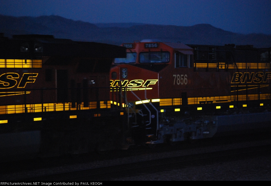 BNSF 7856 rolls west out of BNSF Barstow with a fresh crew in this night flash shot.